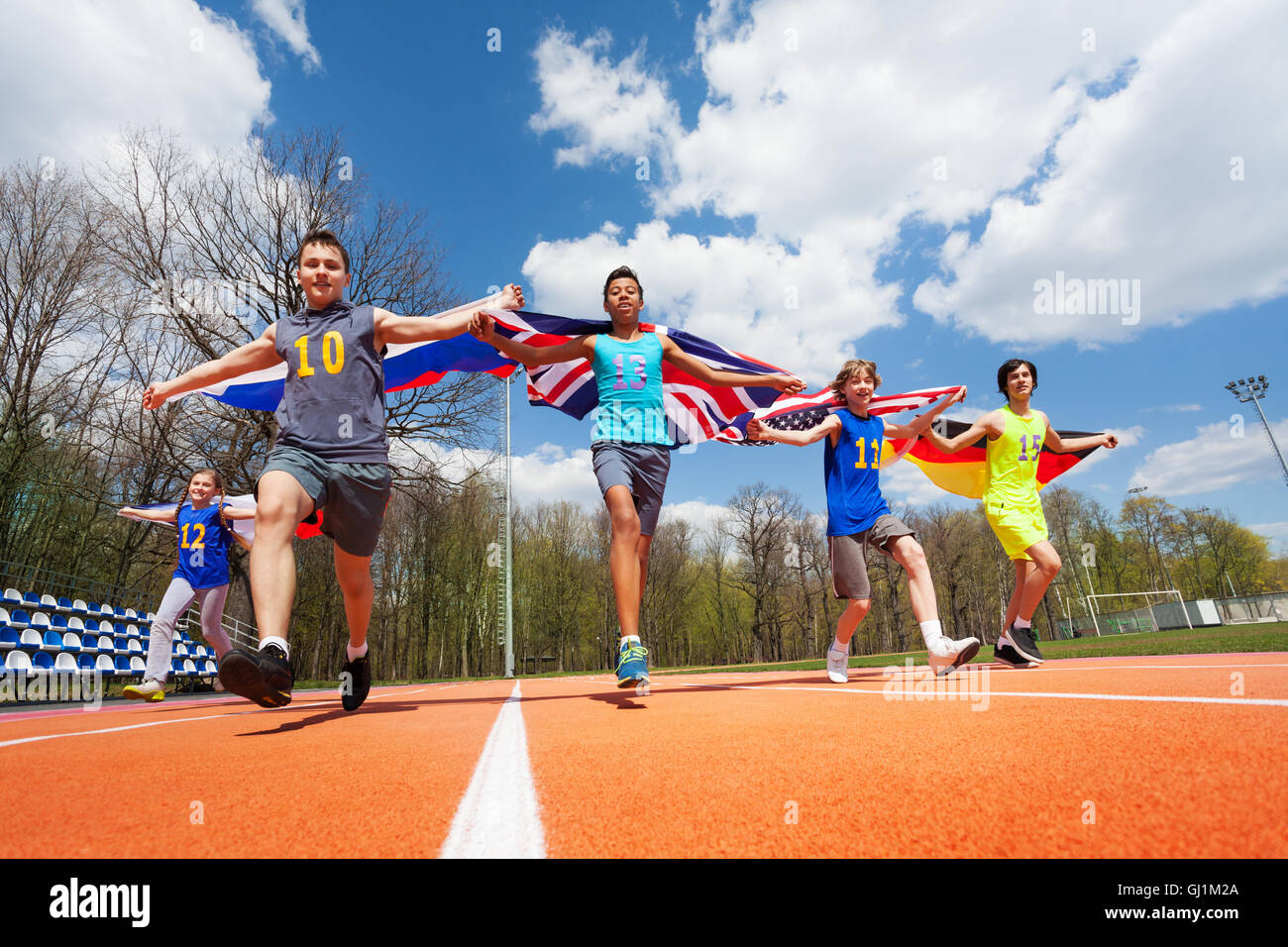 Young multiethnic participants of race with flags Stock Photo - Alamy