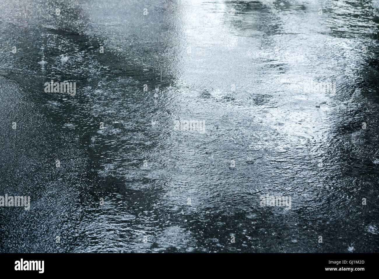 Rain water on street road Stock Photo - Alamy
