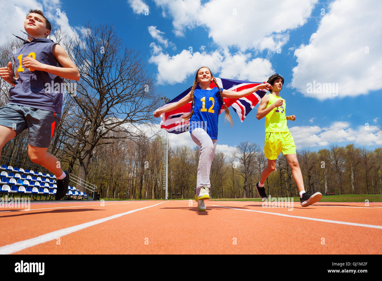 Team of three teenage sprinters with British flag Stock Photo - Alamy