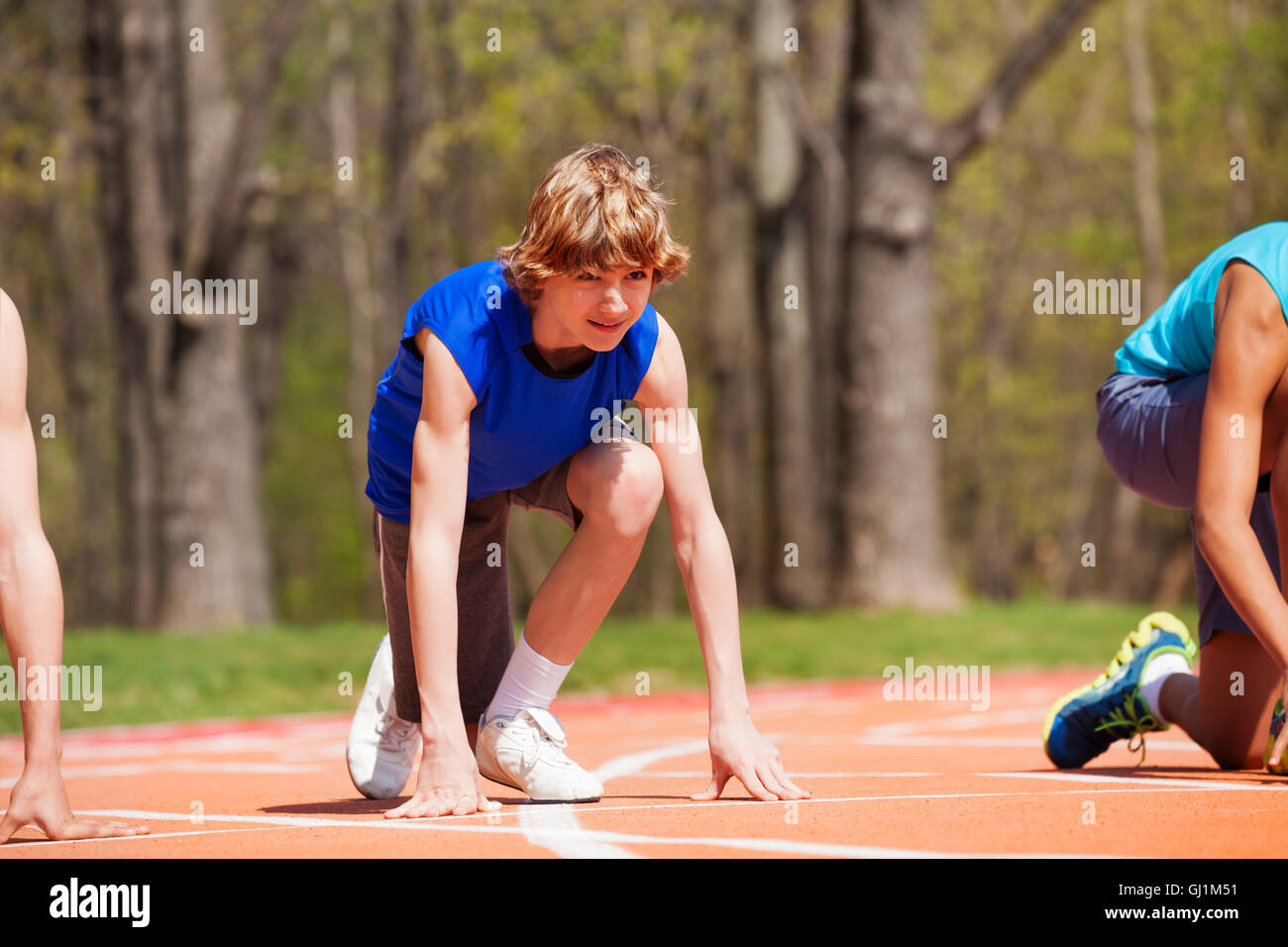 Teenage boy getting ready for race on the track Stock Photo - Alamy