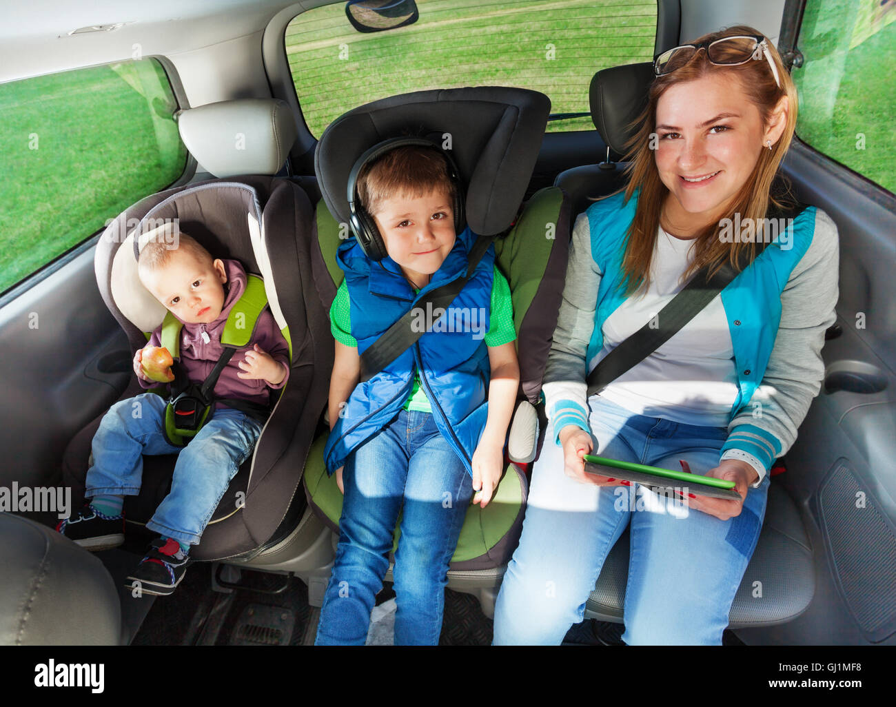 Happy passengers sitting on the backseats of a car Stock Photo - Alamy