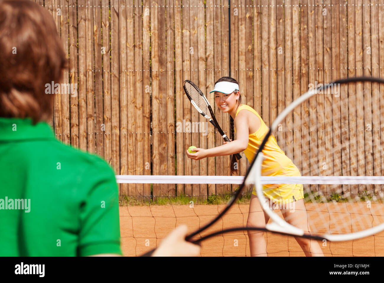 Tennis players playing a match on the clay court Stock Photo - Alamy