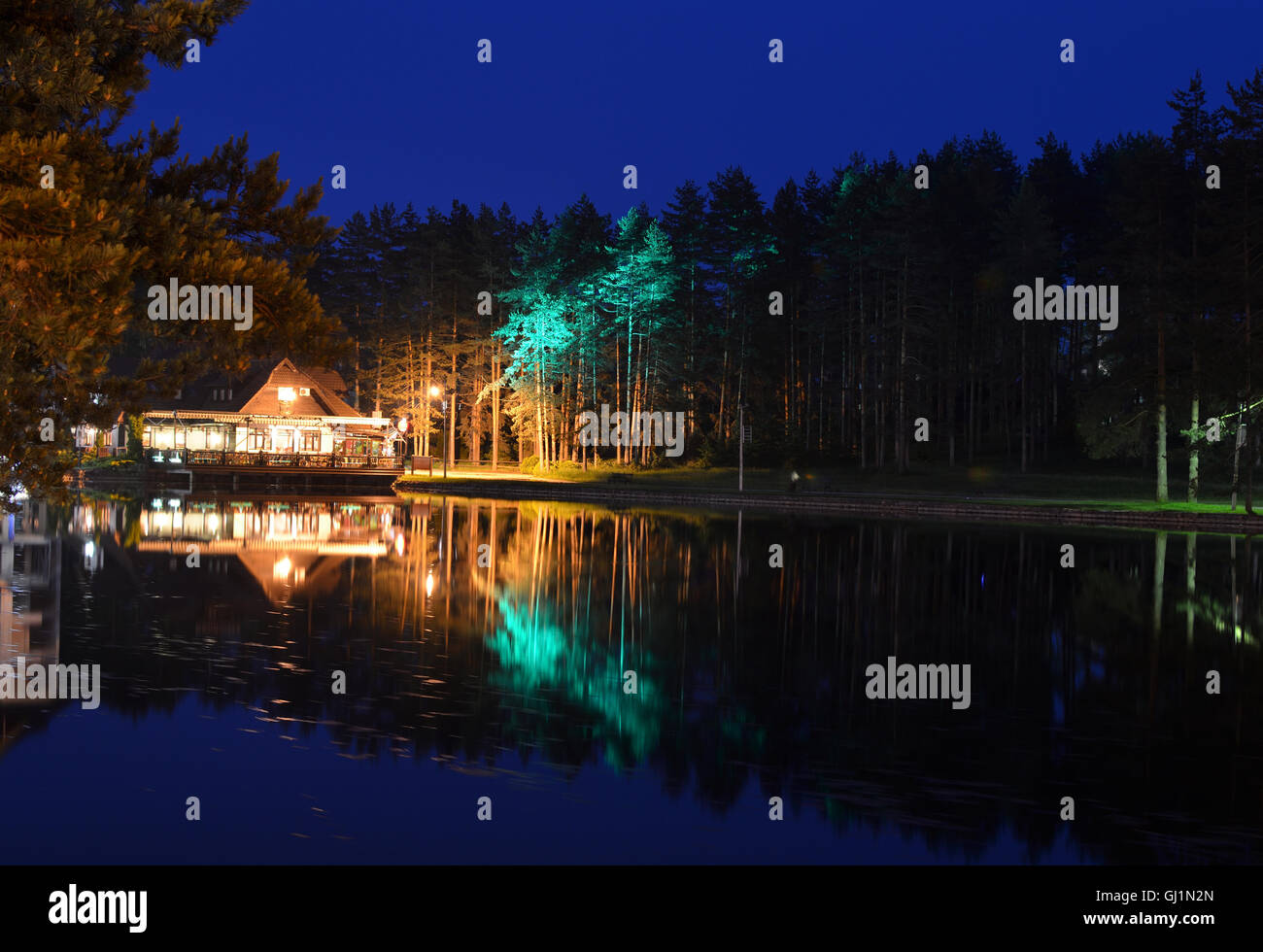 Restaurant and cafe bar on the opposite side of a pond and reflection ...