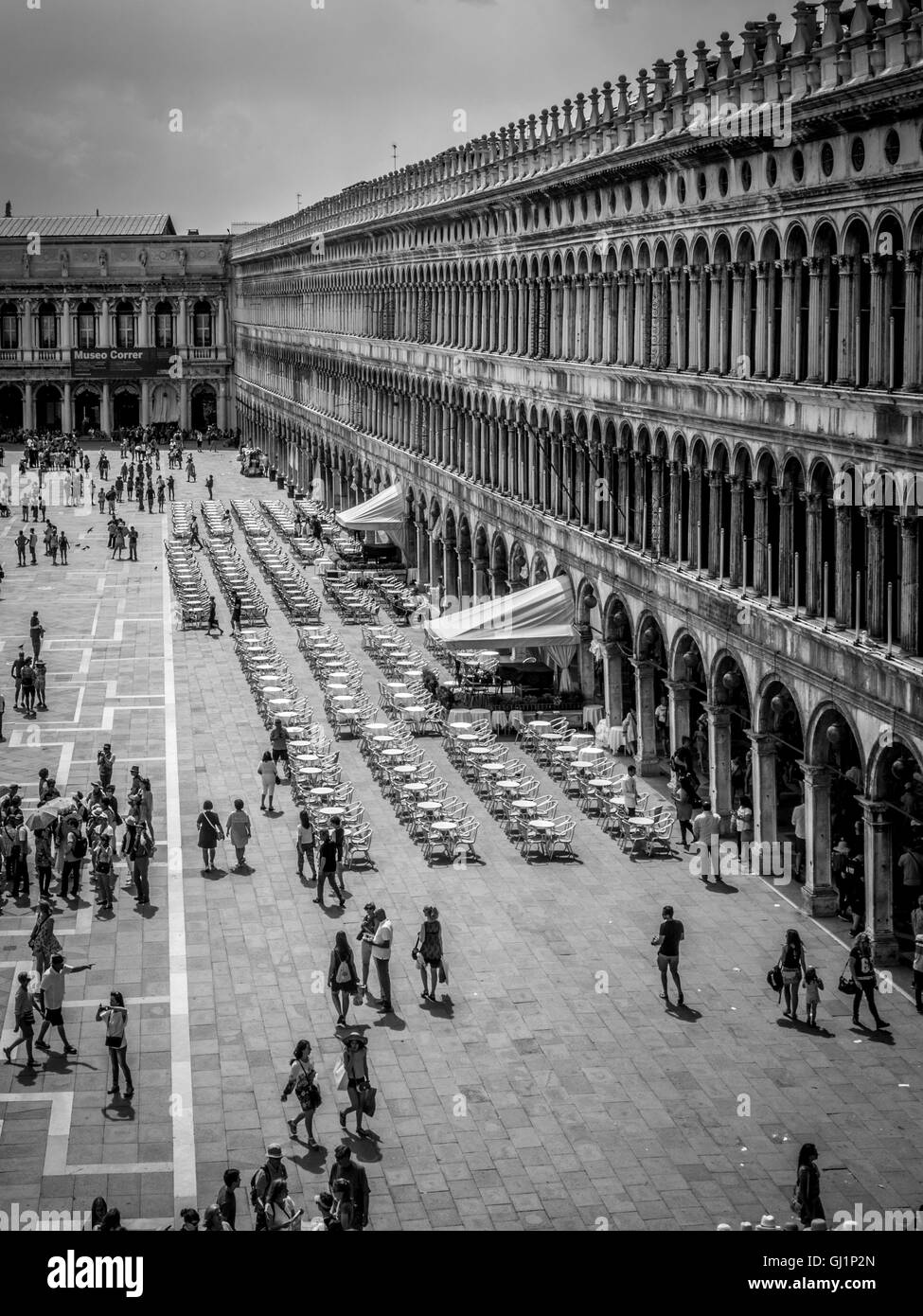 Aerial view of St Mark's square with people sitting at the cafe tables ...