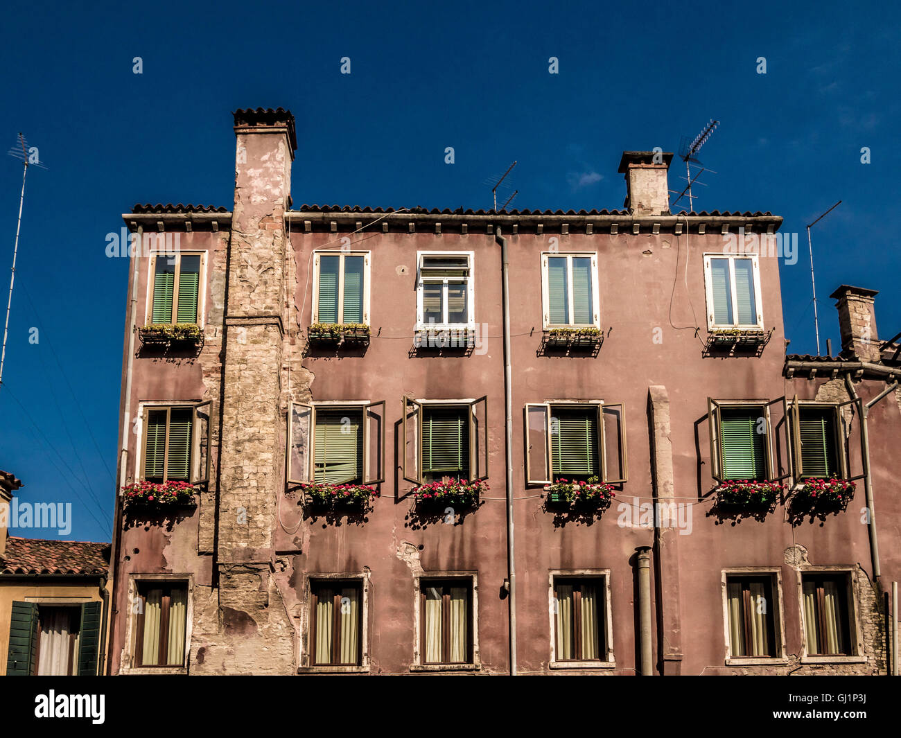 Traditional venetian rendered building. with window boxes and venetian ...