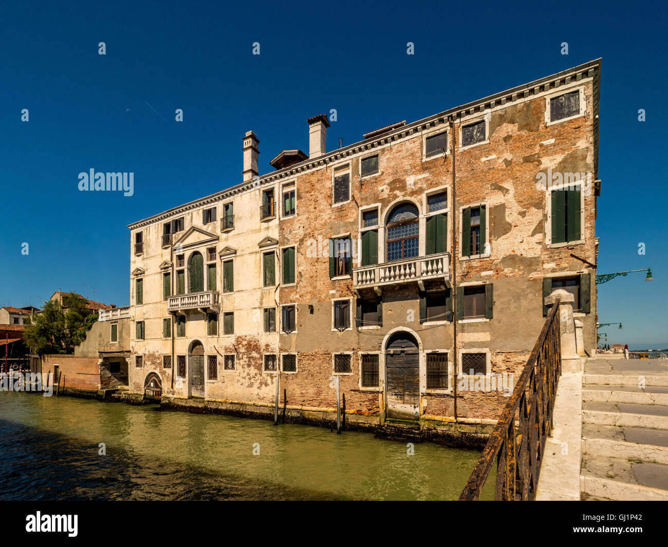 Traditional canal side building, with missing render and exposed bricks ...
