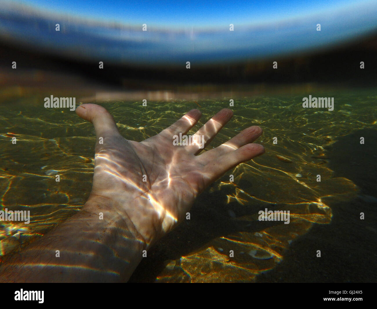 Underwater hand, sea, sand, darkness and light Stock Photo - Alamy