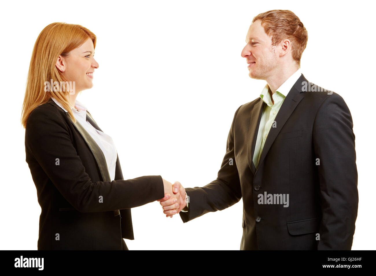 Business handshake between two smiling business people as a greeting ... Business handshake between two smiling business people as a greeting ...