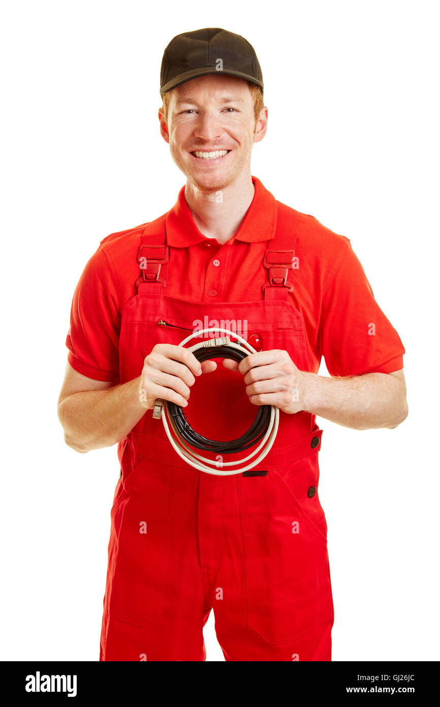 Electrician standing and smiling with a red overall Stock Photo - Alamy