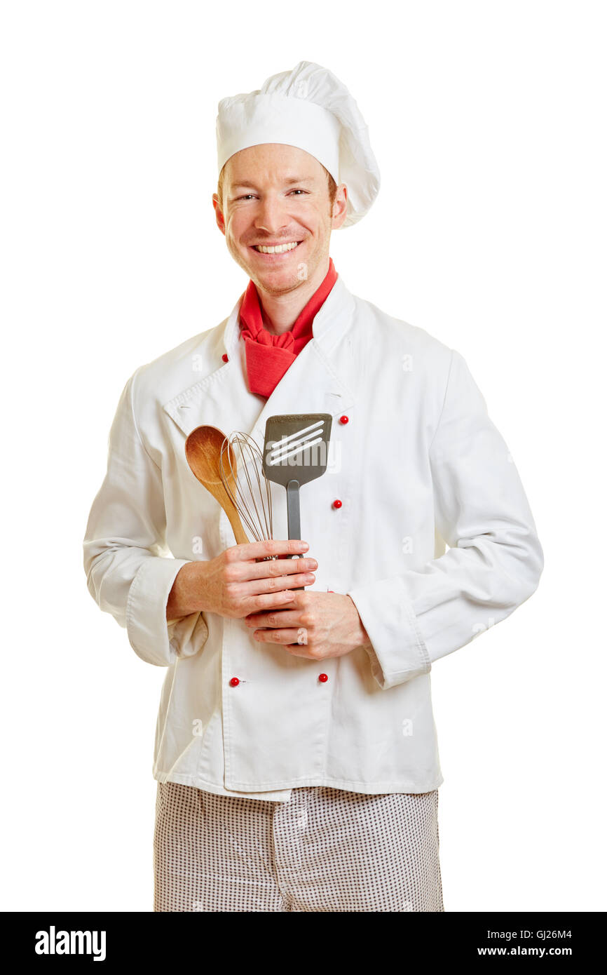 Smiling cook with cook's clothing holding differnt scoops Stock Photo ...