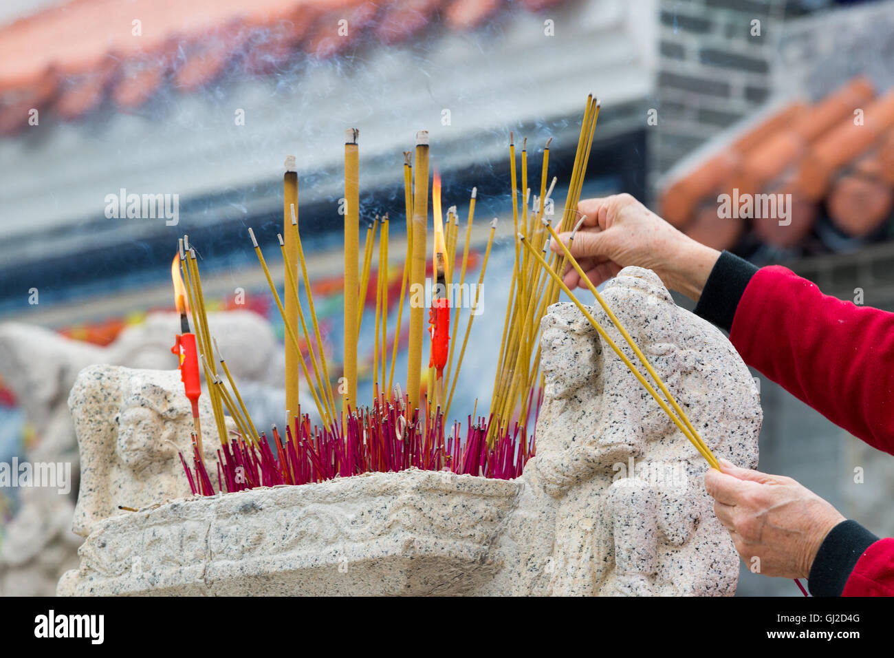 Hands Waving Smoking Incense Sticks at Temple Stock Photo - Alamy