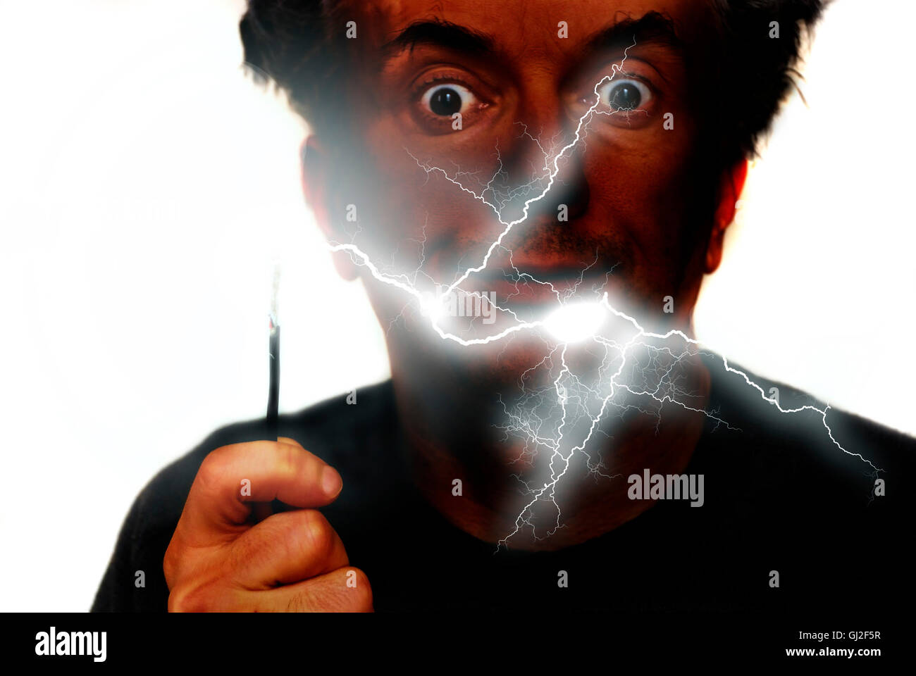 man with burnt face and a wire in his hand Stock Photo - Alamy