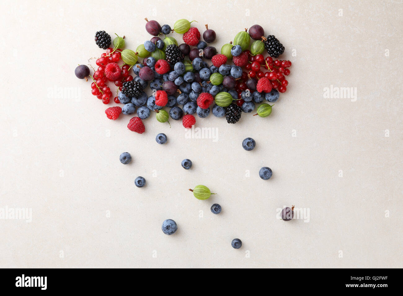 Berry rain from cloud, food background, fruits above Stock Photo - Alamy