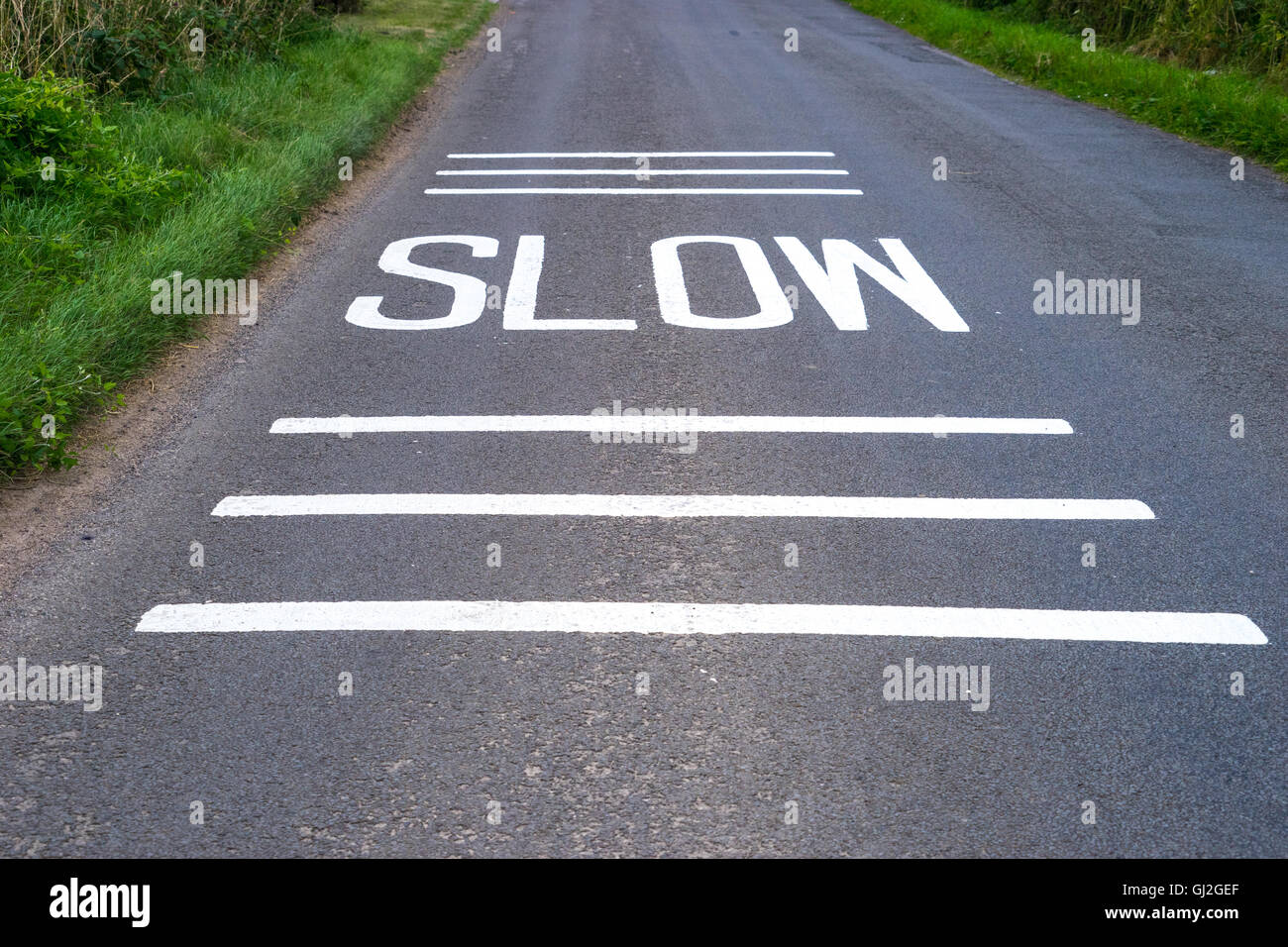 Slow road marking hi-res stock photography and images - Alamy