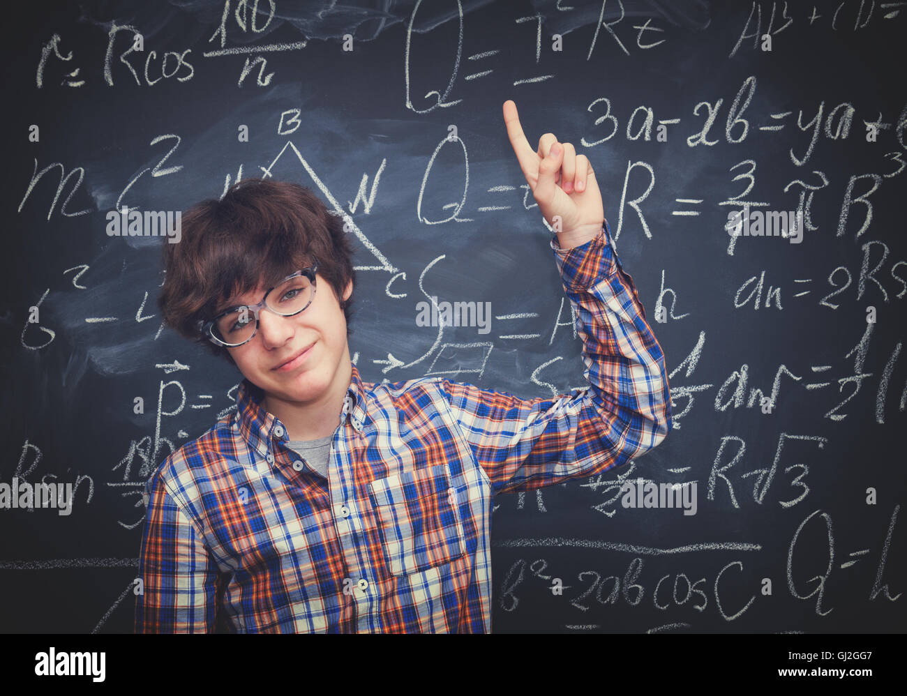 Boy and blackboard filled with math formulas Stock Photo - Alamy