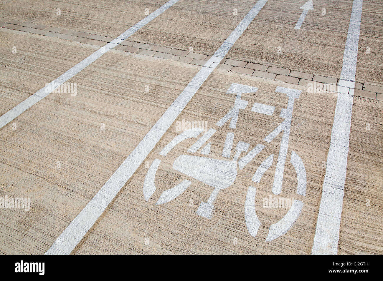 White Bike Lane Sign Painted on Pavement Stock Photo - Alamy