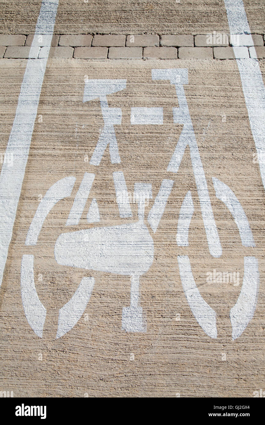 White Bike Lane Sign Painted on Pavement Stock Photo - Alamy