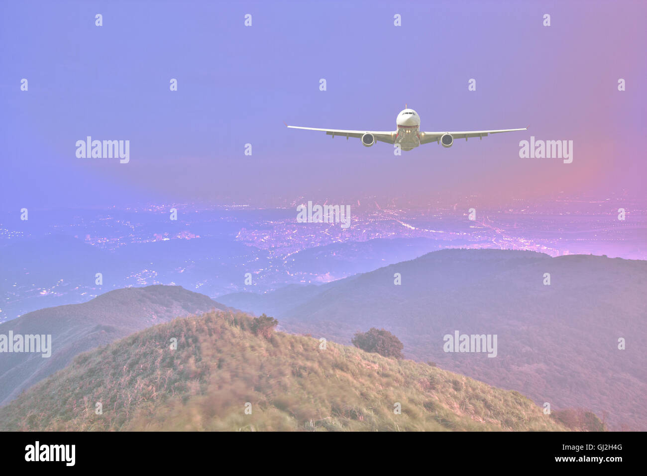 perspective view of jet airliner in flight above mountains and fog and ...