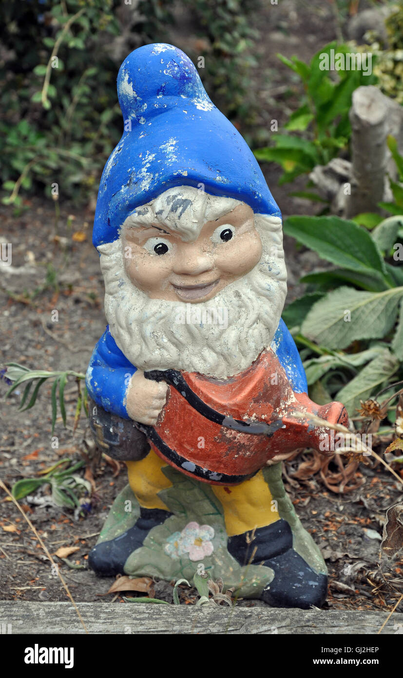 Old weathered garden gnome decoration Stock Photo - Alamy