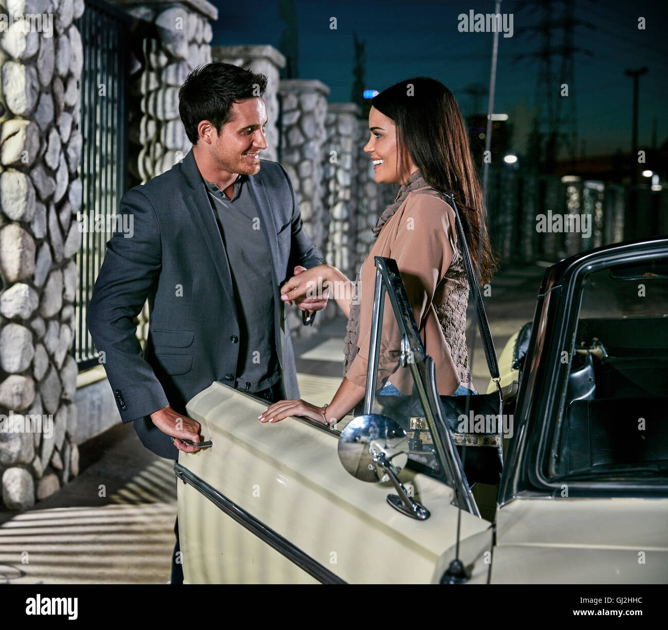 Man helping woman out of car night hi-res stock photography and images ...