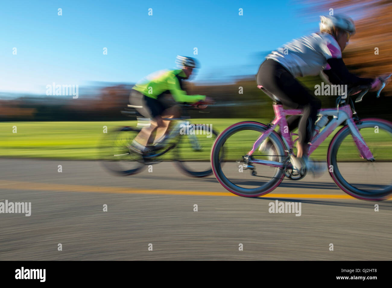 Blurred motion side view of cyclists cycling Stock Photo - Alamy