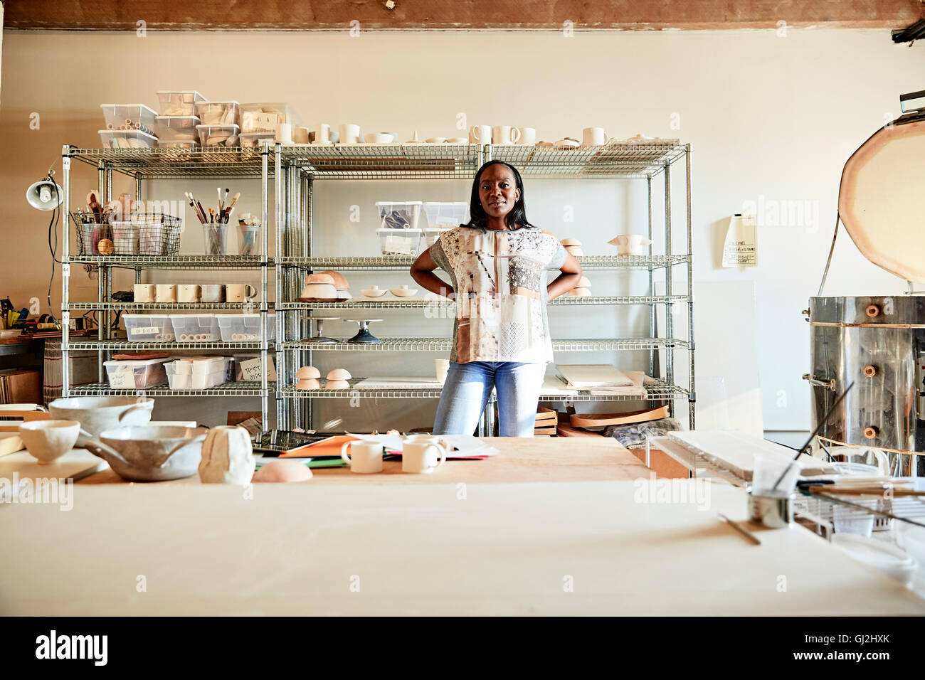 Woman in pottery studio looking at camera smiling Stock Photo - Alamy