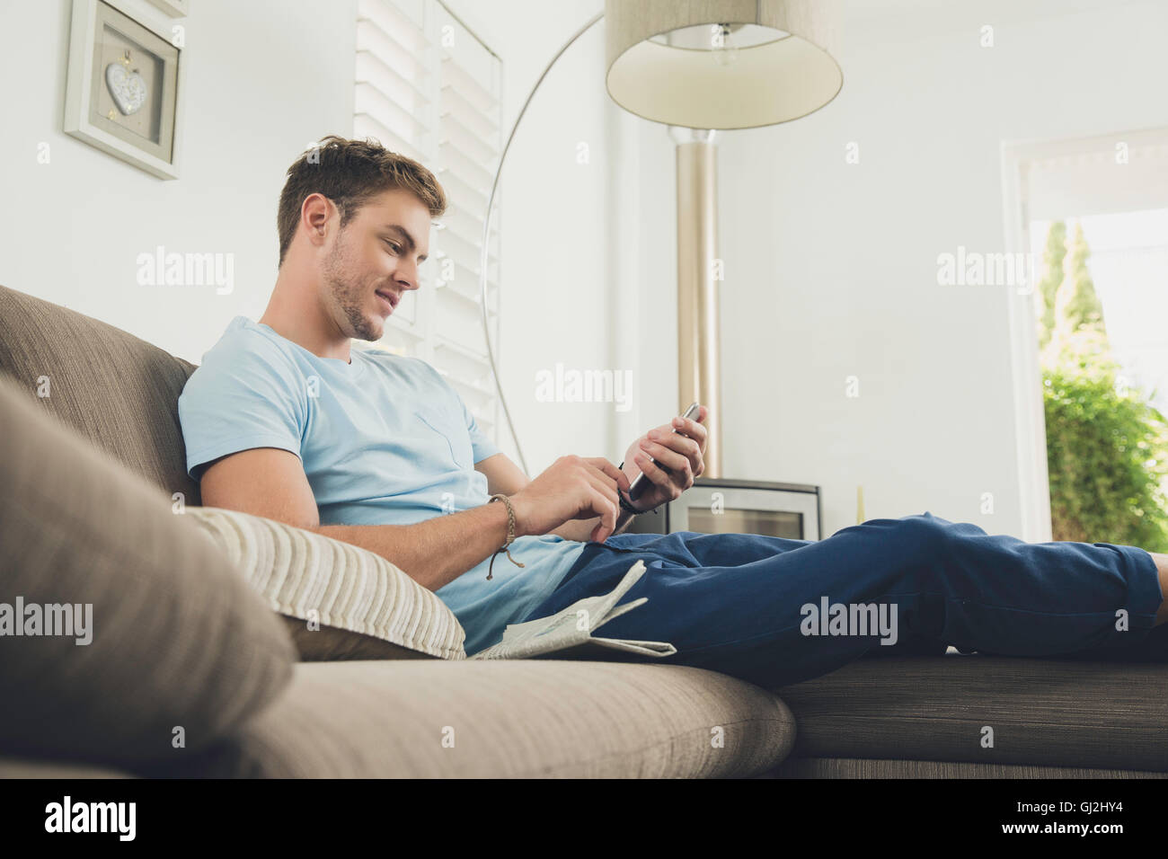 Texting sofa hi-res stock photography and images - Alamy