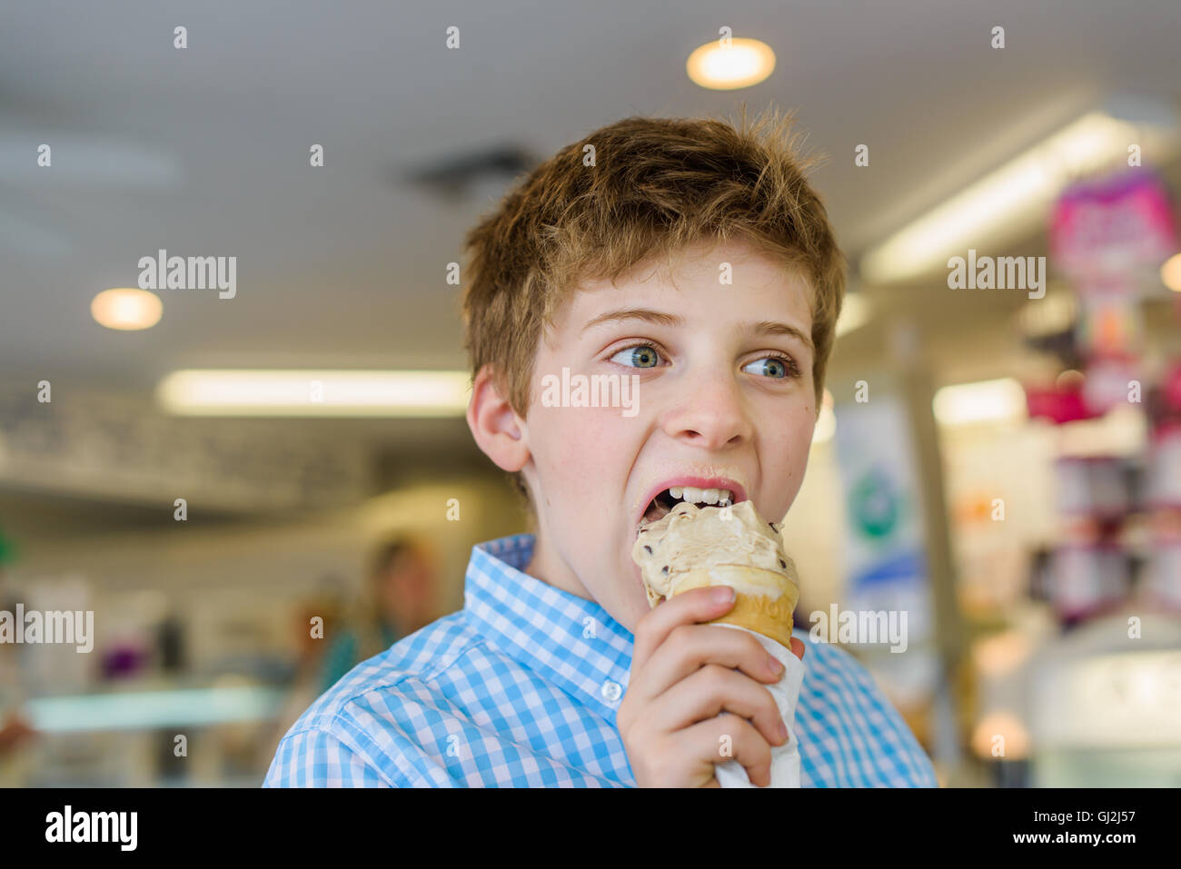 Boy eating ice cream cone Stock Photo - Alamy