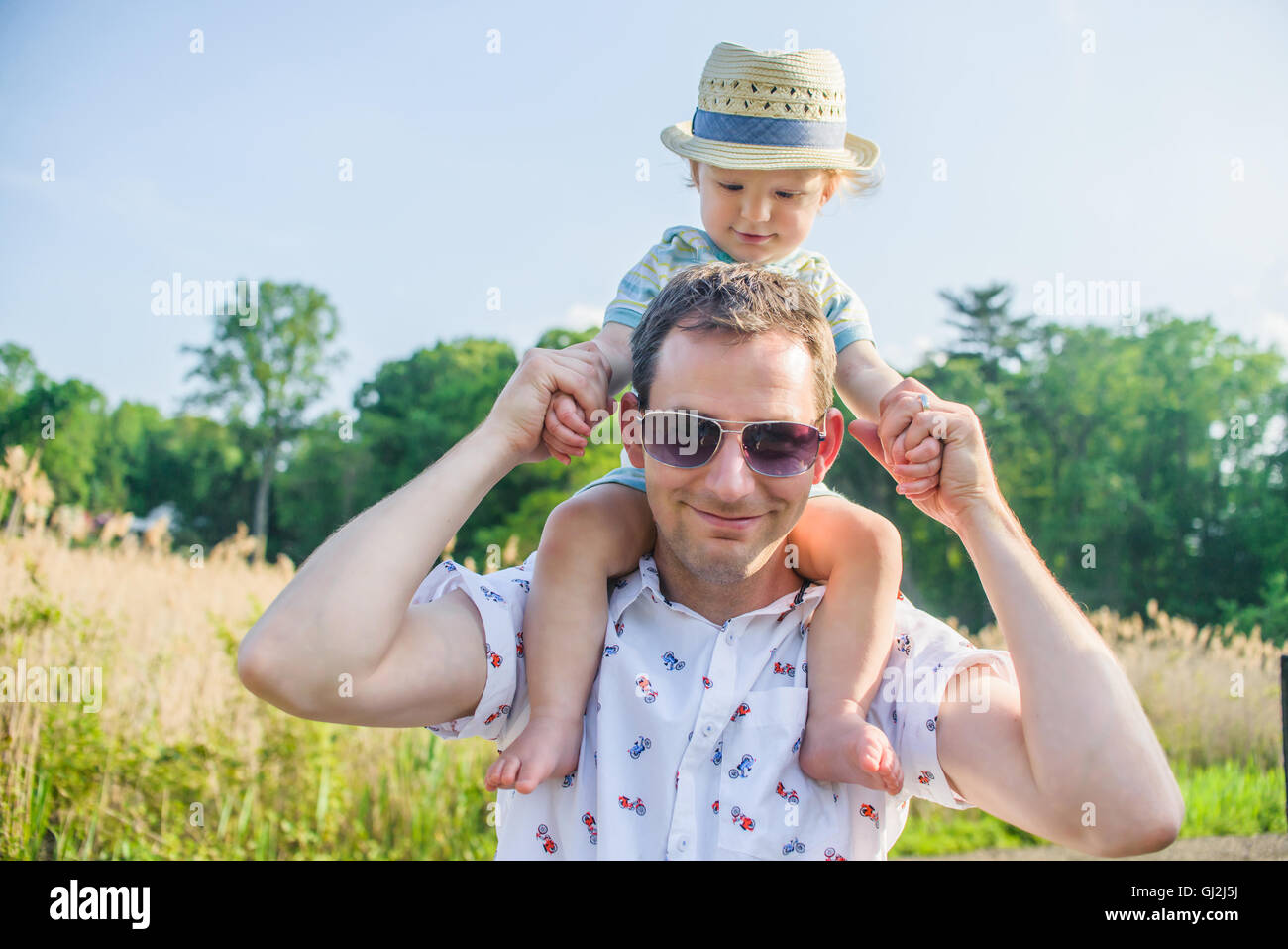 Father carrying baby boy on shoulders Stock Photo - Alamy