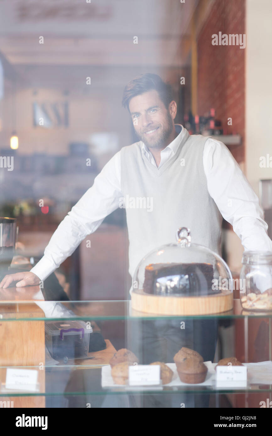 Portrait of mature man behind counter in cafe Stock Photo - Alamy