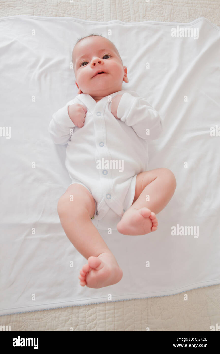 Overhead full length view of baby boy looking at camera Stock Photo - Alamy