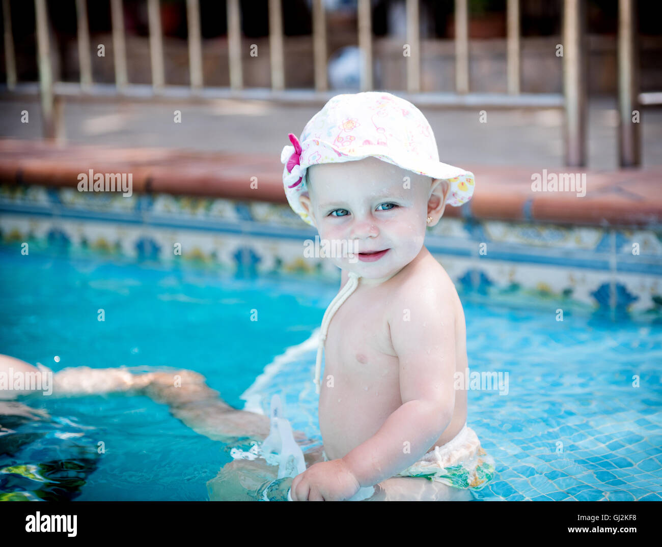 Cute toddler girl playing in swimming pool Stock Photo - Alamy