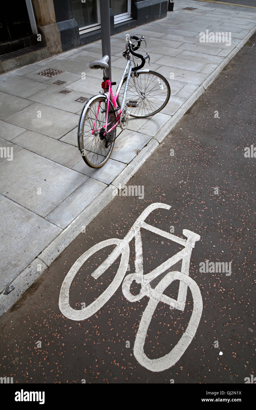 Bicycle secured to a post by the cycle lane in Edinburgh Stock Photo ...