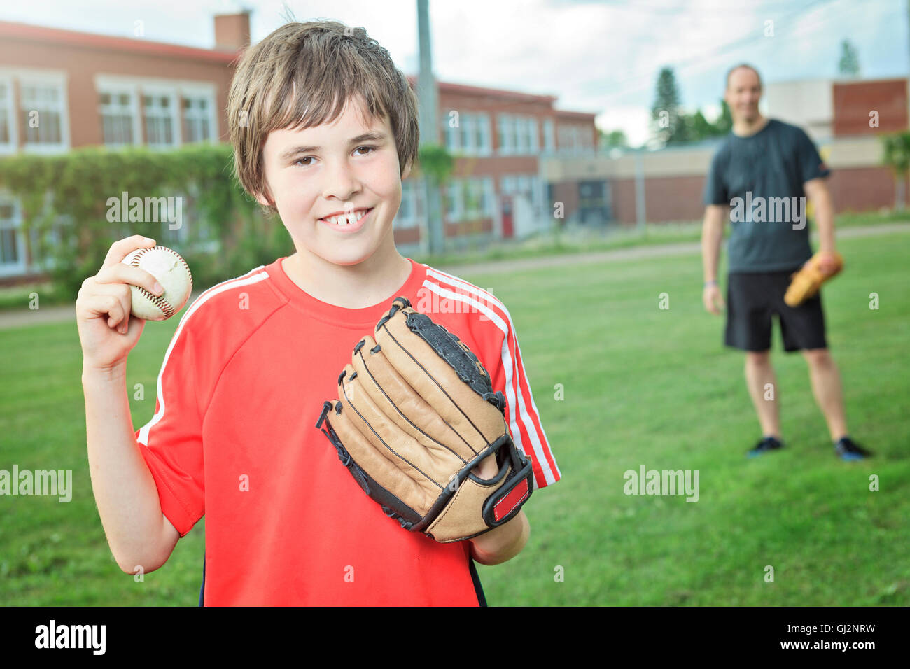 A Portrait of a father and son play baseball in a field Stock Photo - Alamy