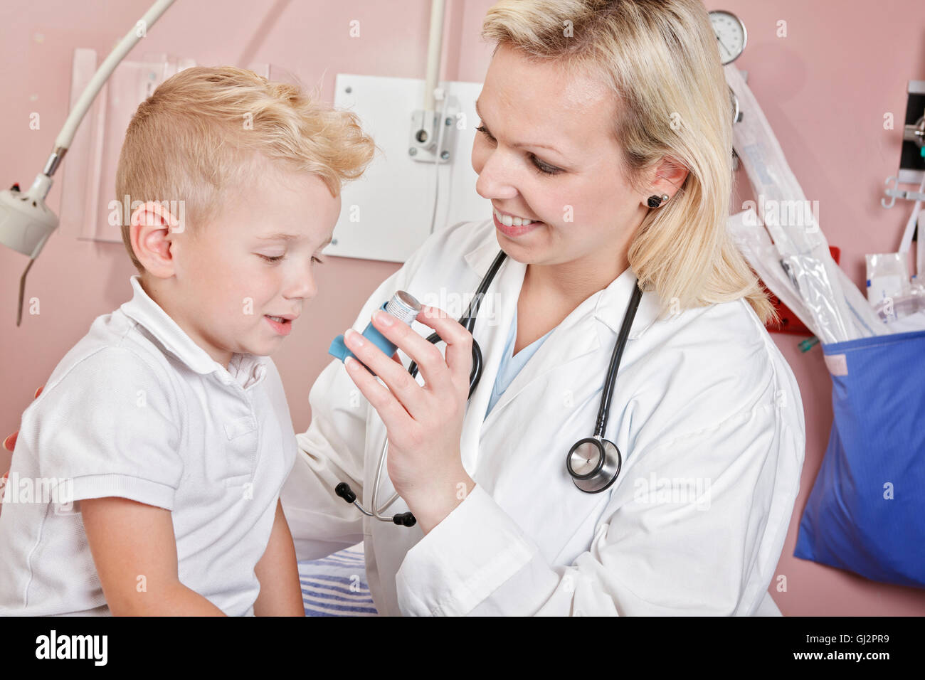 A Medical doctor applying oxygen treatment on a little boy with asthma ...