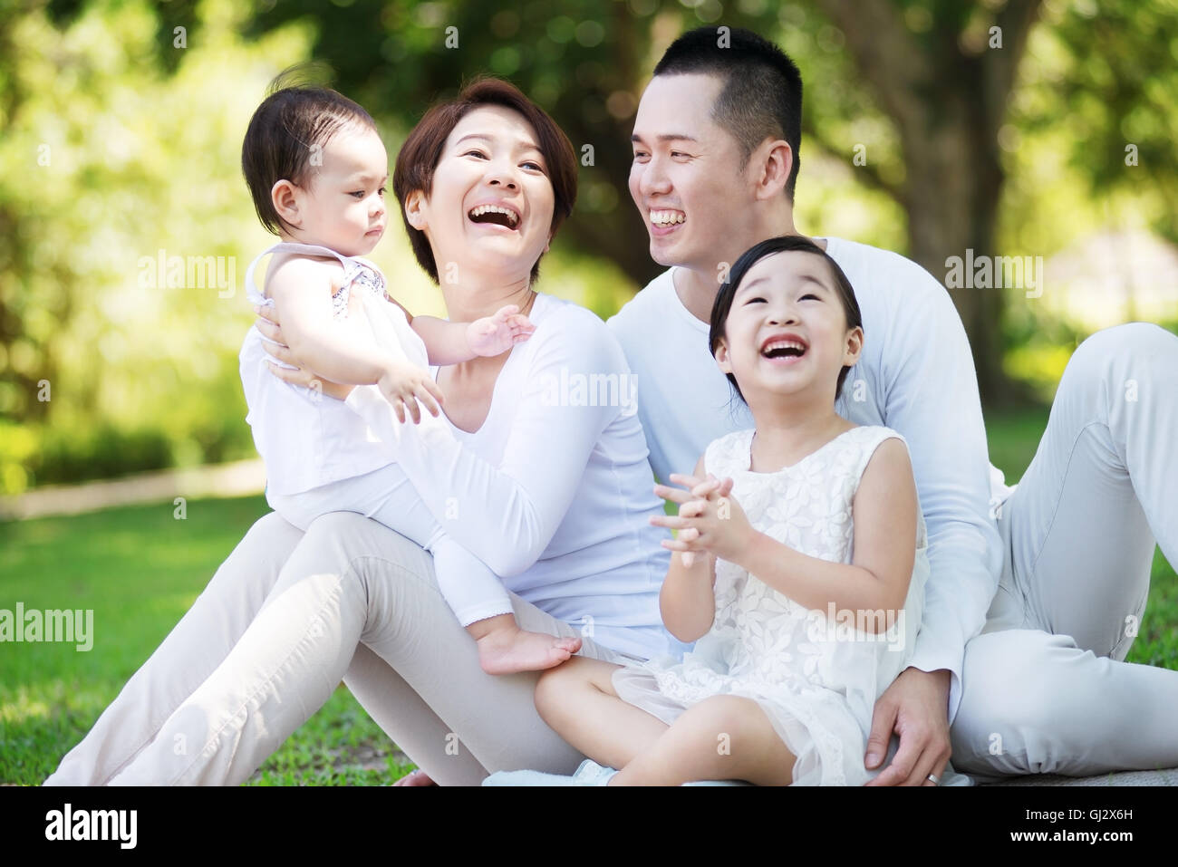 Happy Asian family in the park Stock Photo - Alamy