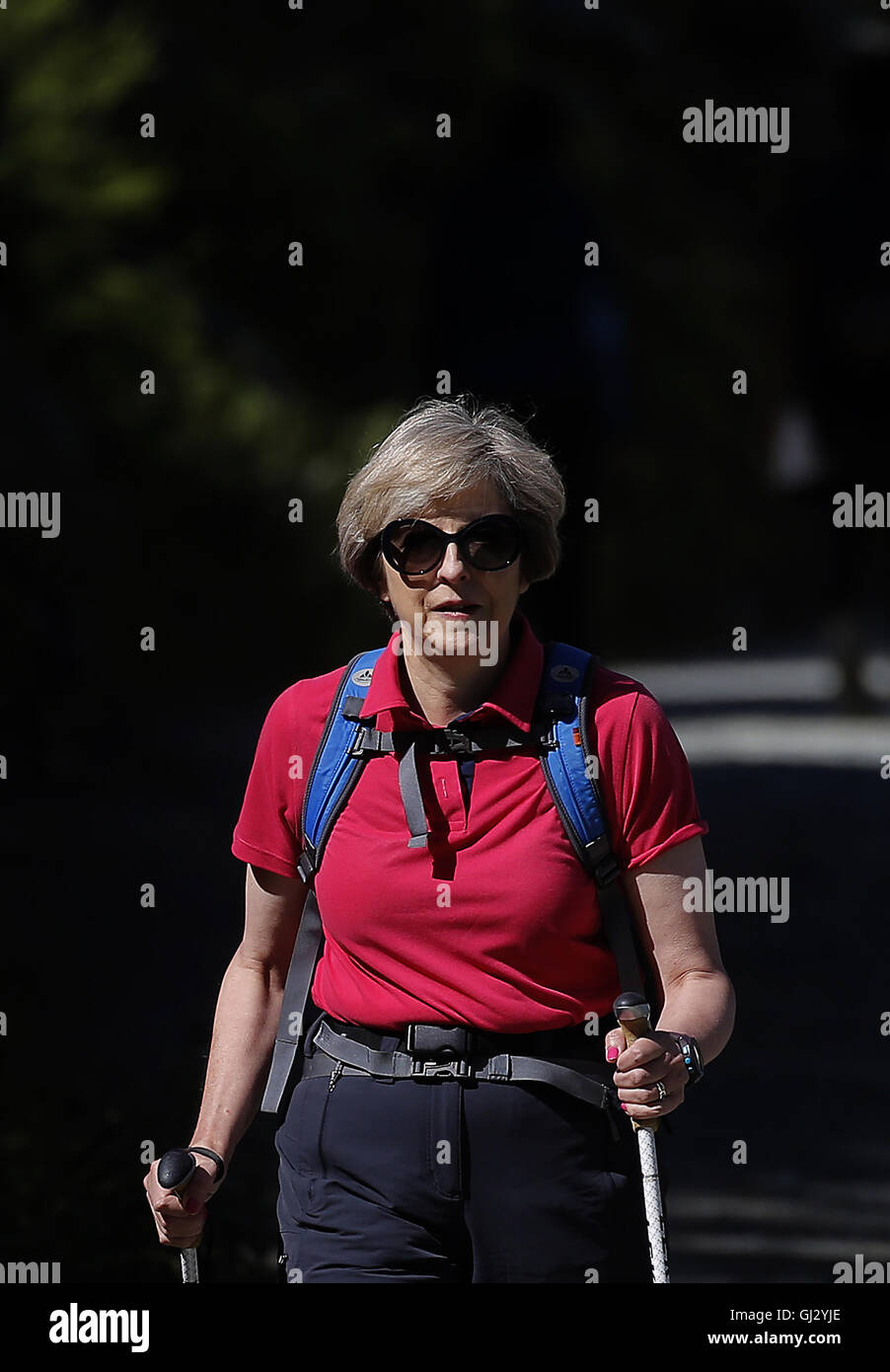 Prime Minister Theresa May walks in a forest at the start of a summer ...