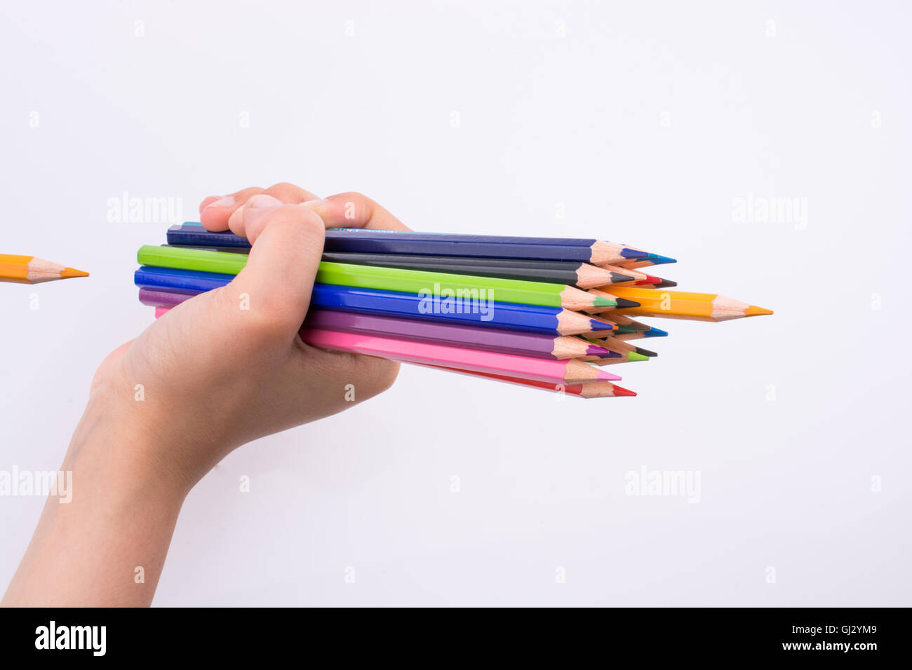 Hand holding color pencils on a white background Stock Photo - Alamy