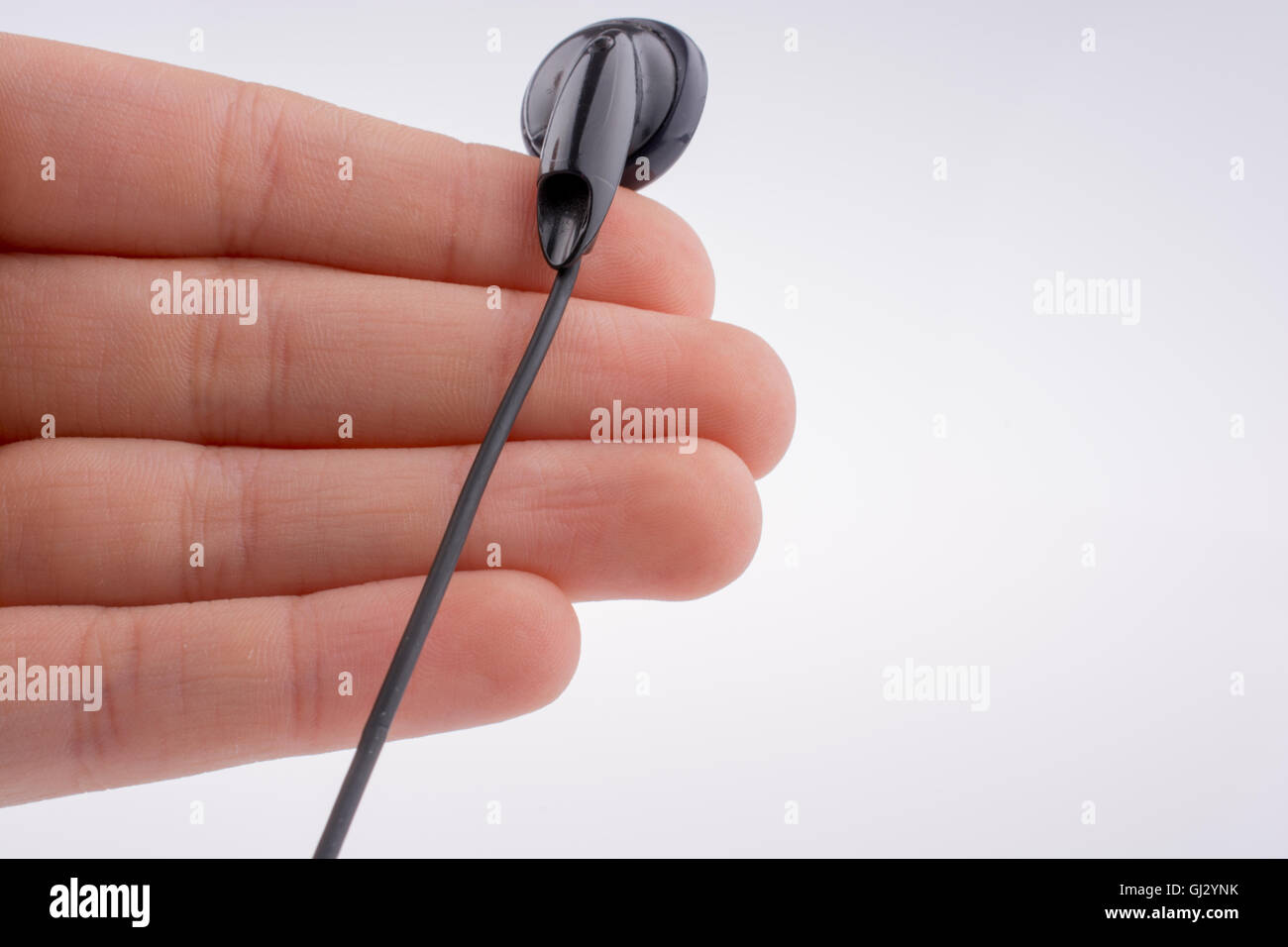 Hand holding ear buds hi-res stock photography and images - Alamy
