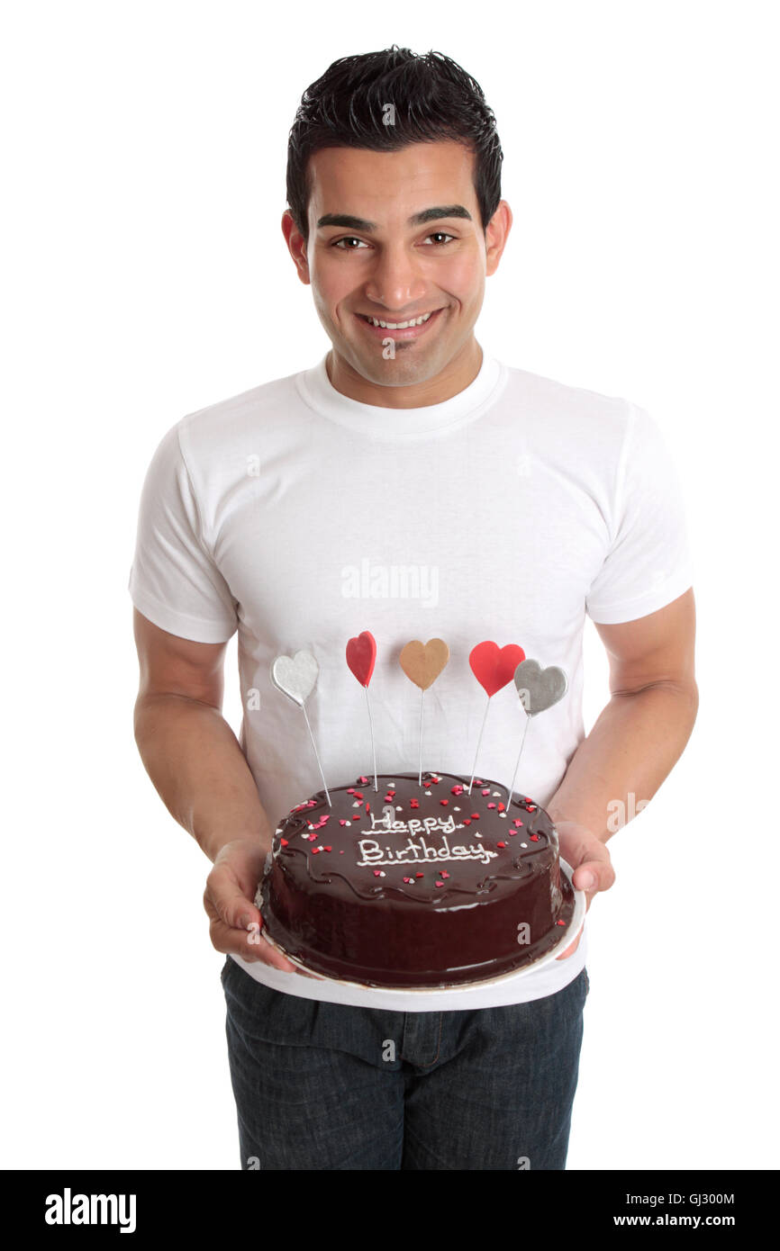 Man carrying chocolate cake decorated with hearts Stock Photo - Alamy