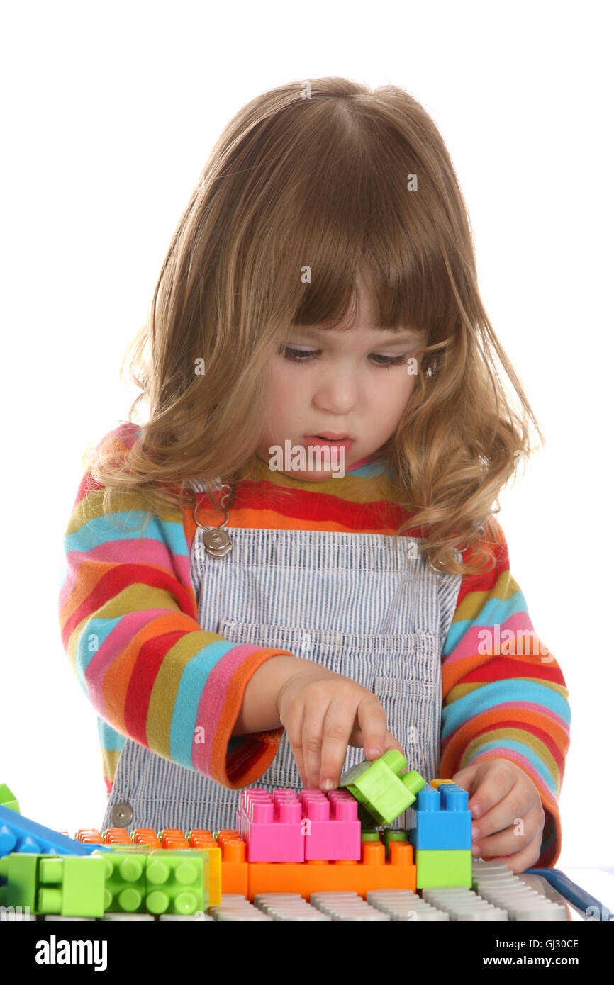 girl playing colorful building toy blocks Stock Photo - Alamy