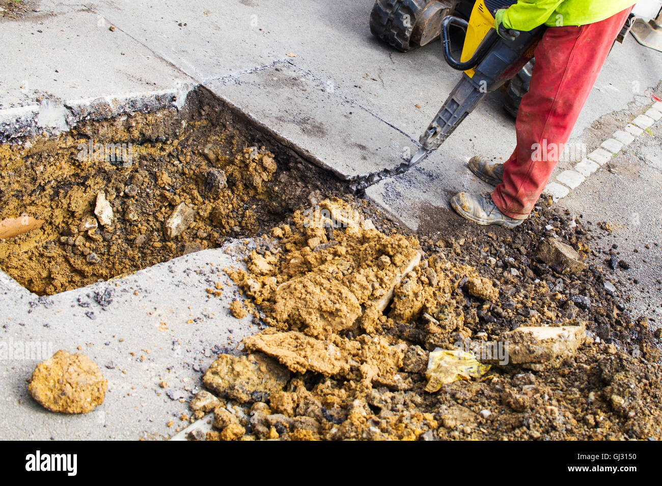Workmen digging the pavement to repair underground Electricity cable ...