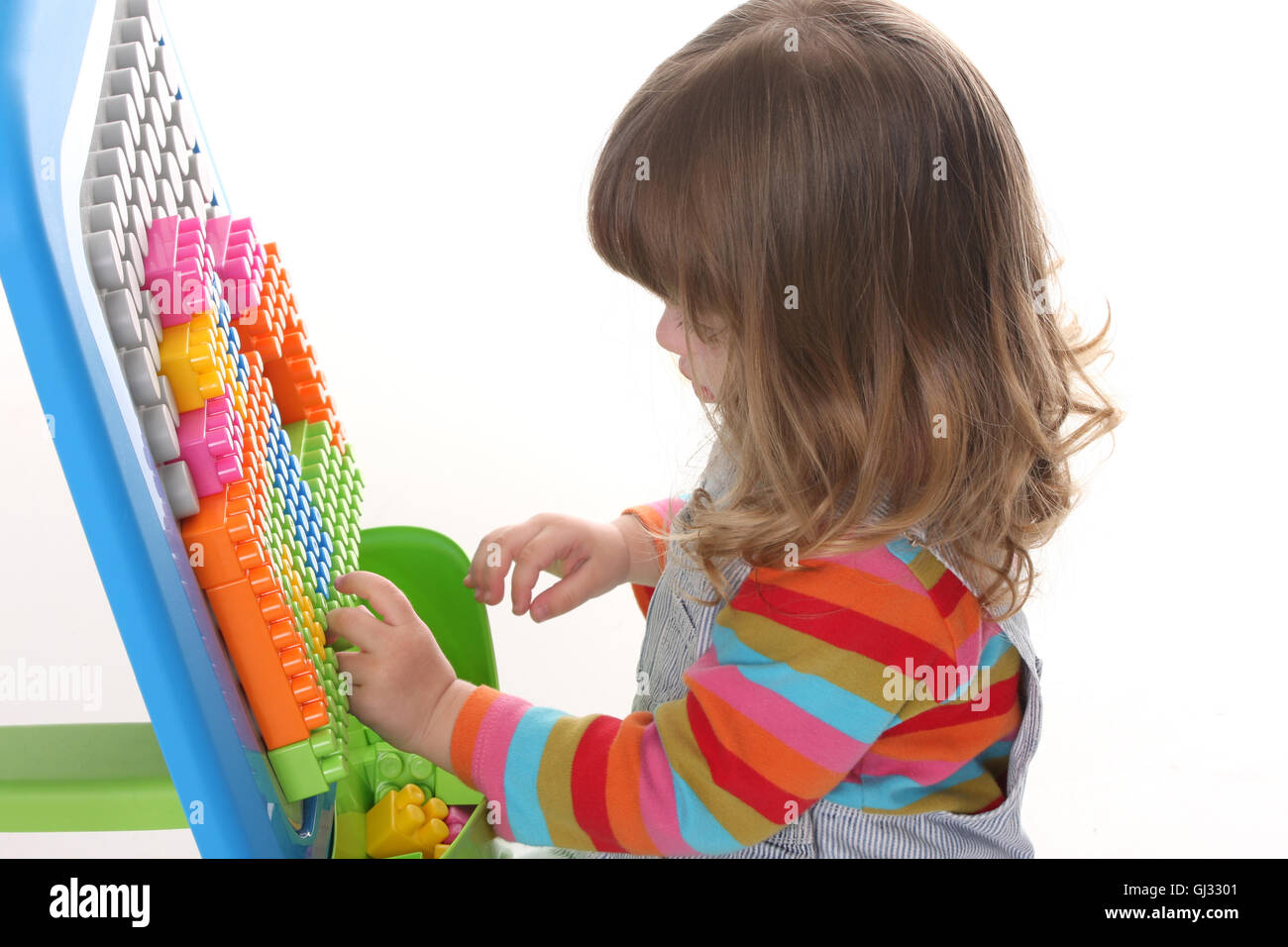 girl playing colorful building toy blocks Stock Photo - Alamy