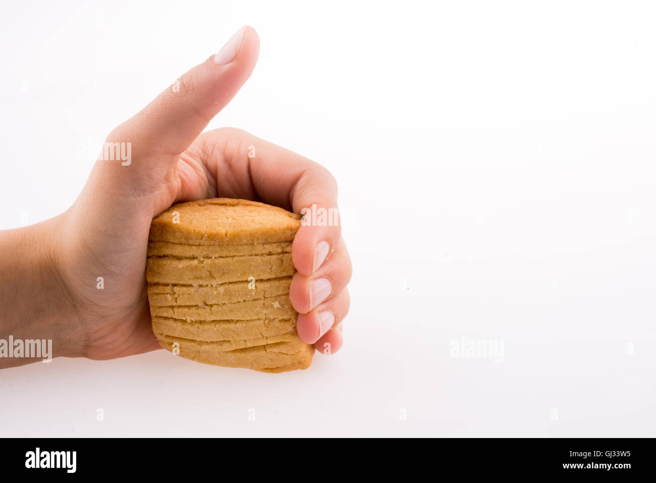 Hand holding square cookie a white background Stock Photo - Alamy