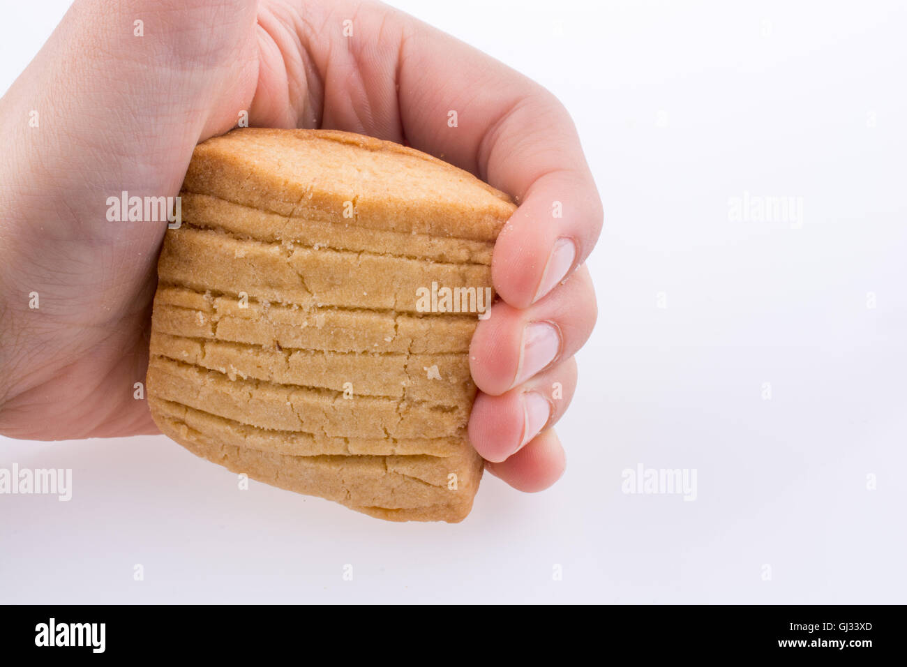 Hand holding square cookie a white background Stock Photo - Alamy