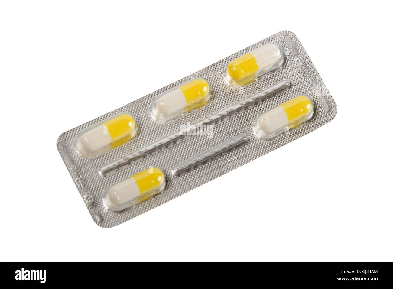 Yellow-white pills in metallic blister Stock Photo - Alamy