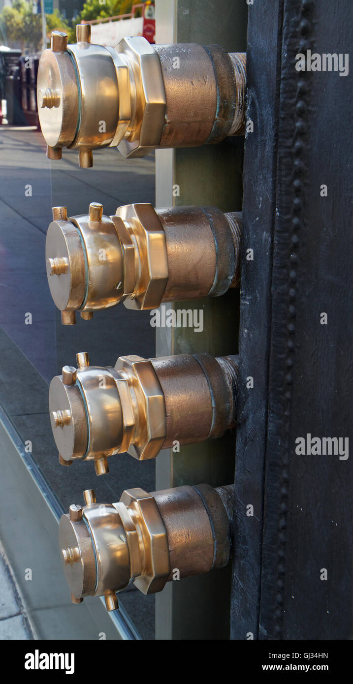 Four brass fire hose connections Stock Photo - Alamy