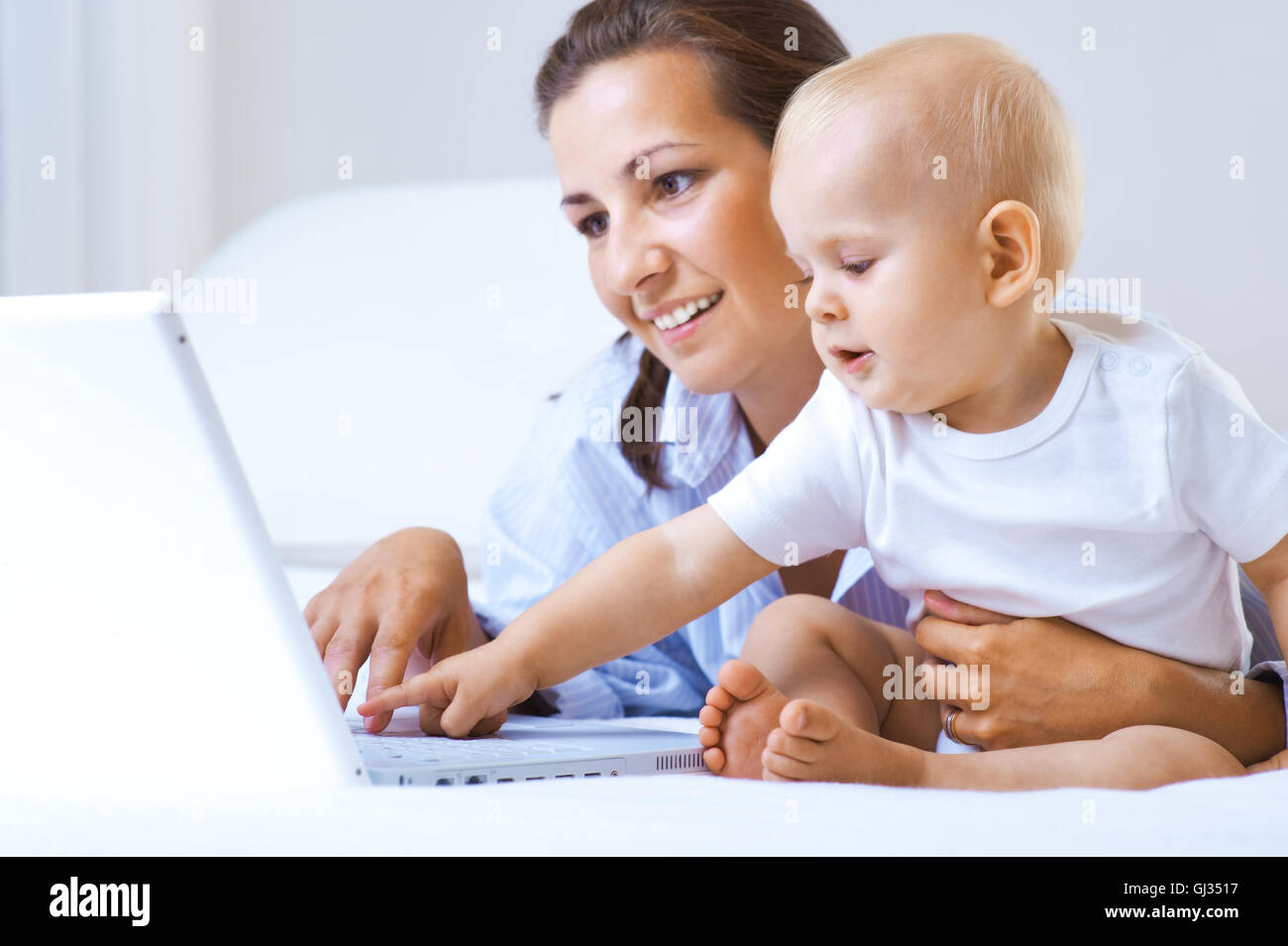 Mother and baby with laptop Stock Photo - Alamy