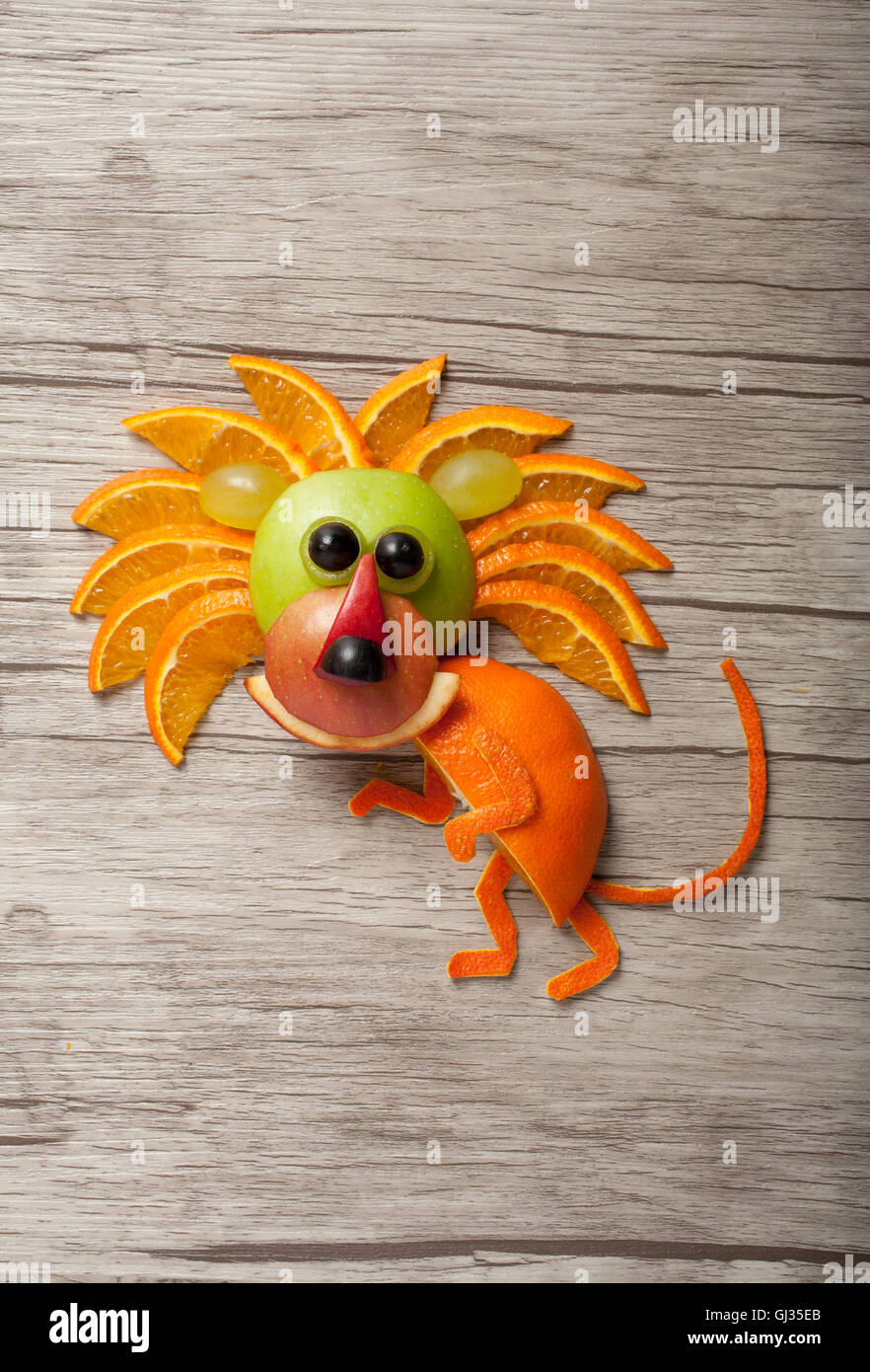 Amusing lion made of fruits on wooden background Stock Photo - Alamy