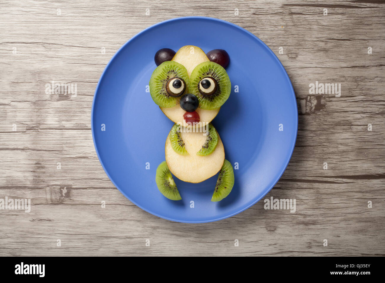 Panda made of fruits on plate and board Stock Photo - Alamy